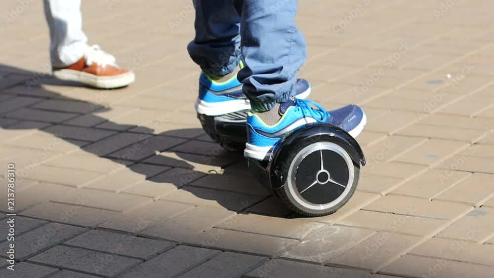 Boy legs riding segway on a pedestrian public street place slow motion ...