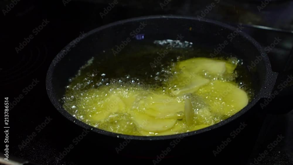 Slow motion of frying foods in a pan with high temperature until ...