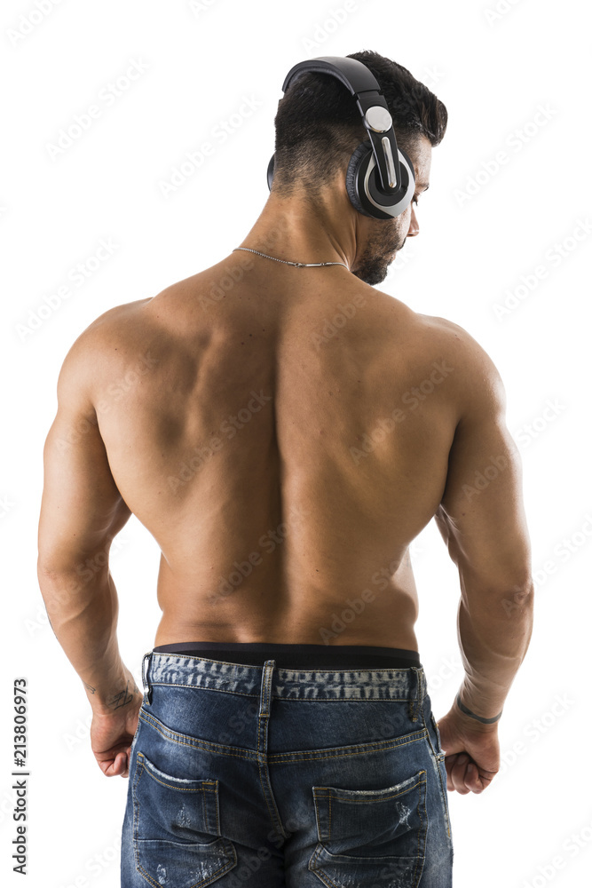 Back of shirtless muscular bodybuilder man listening to music with ...