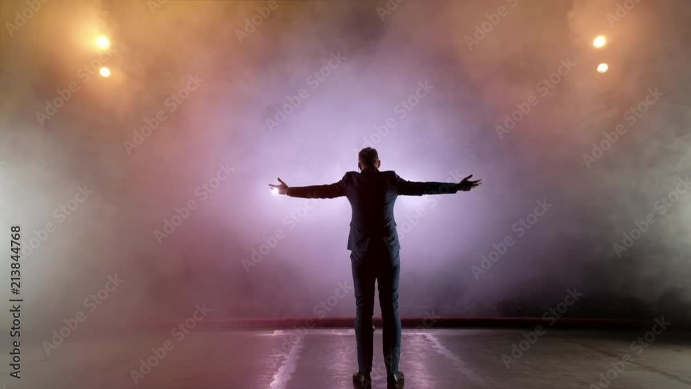 Showman. Young male entertainer, presenter or actor on stage. Back ...