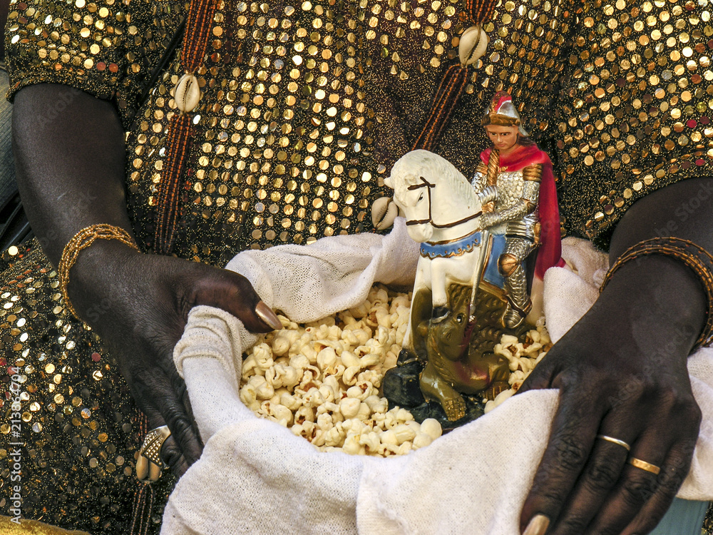 Foto de Mother of Candomble saint holds a basket with popcorn and the ...