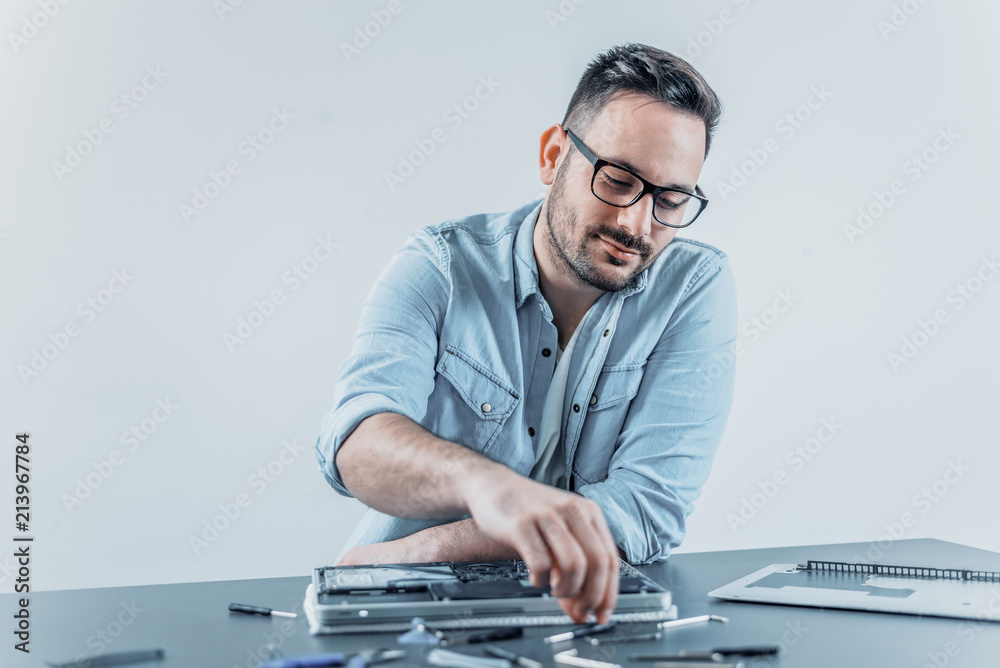 Engineer choosing the right tool for the repair of laptop hardware ...