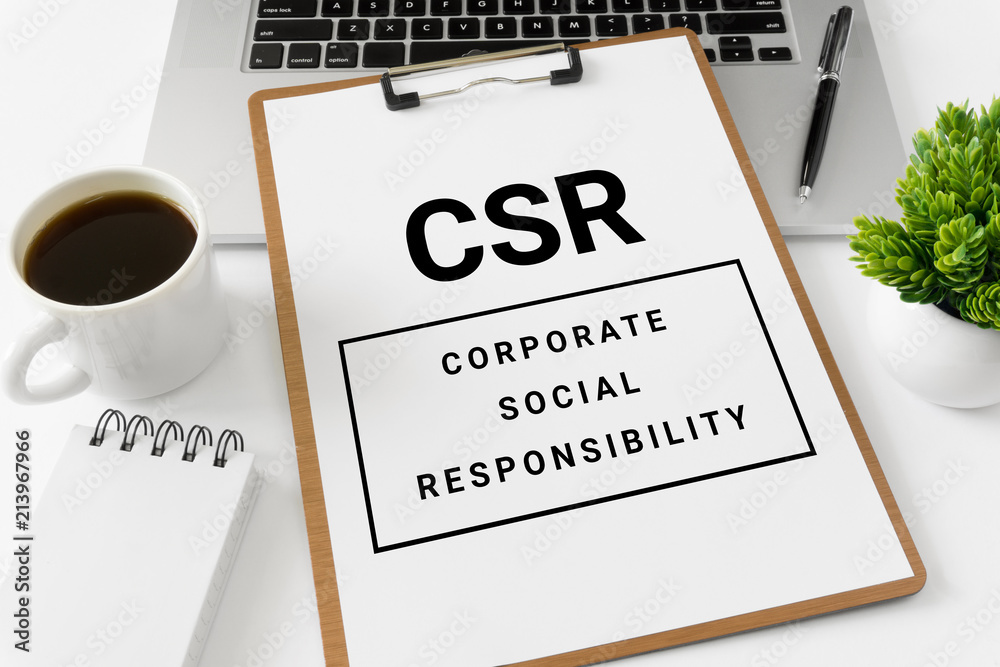 CSR Corporate Social Responsibility on white paper placed on top of ...