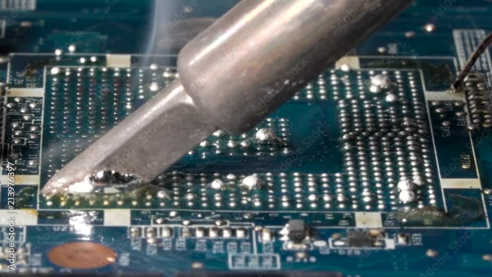 Removing bga balls from the pcb. bga rework station. Closeup macro ...