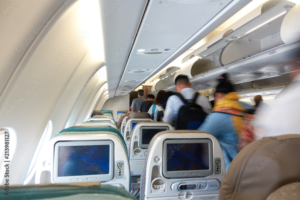 Passengers disembark from the aircraft cabin economy class Stock Photo ...