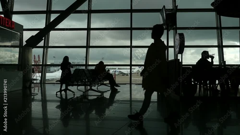 Unrecognizable passengers walking inside the air terminal, airport ...