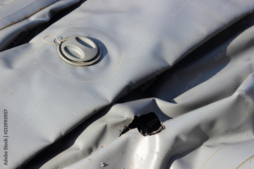 Damaged by mice gray fishing inflatable boat PVC, the rat chewed a hole ...
