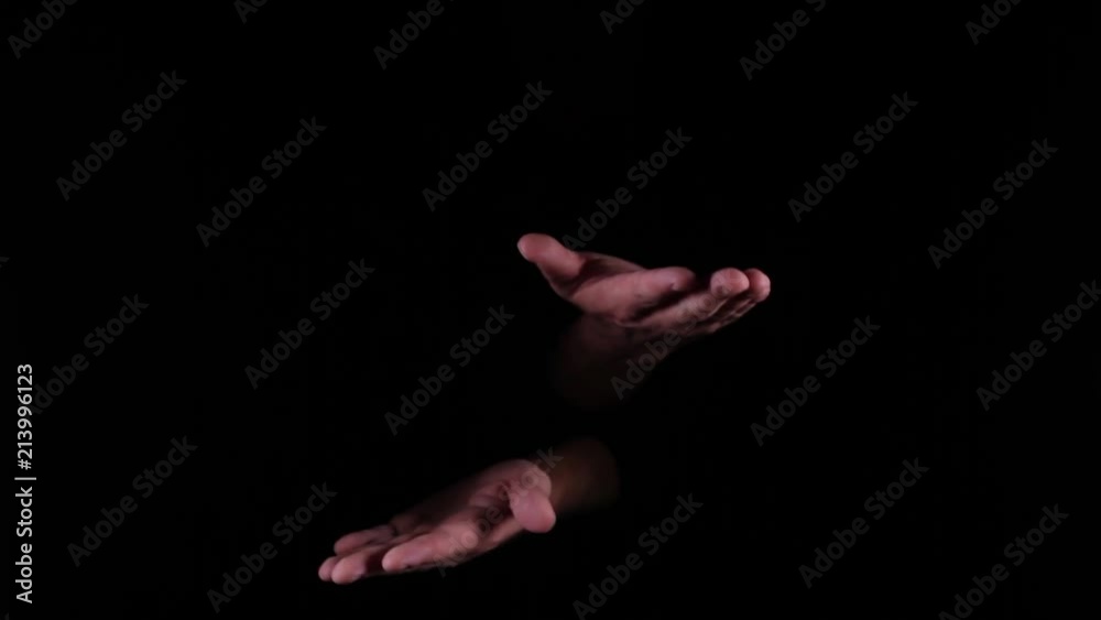 Vidéo Stock Hand Gestures coming out of the dark into the light ...