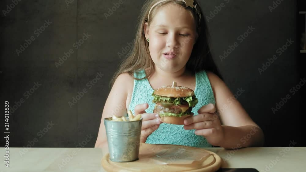 fat girl eagerly eating a hamburger, concept of a healthy diet Stock ...