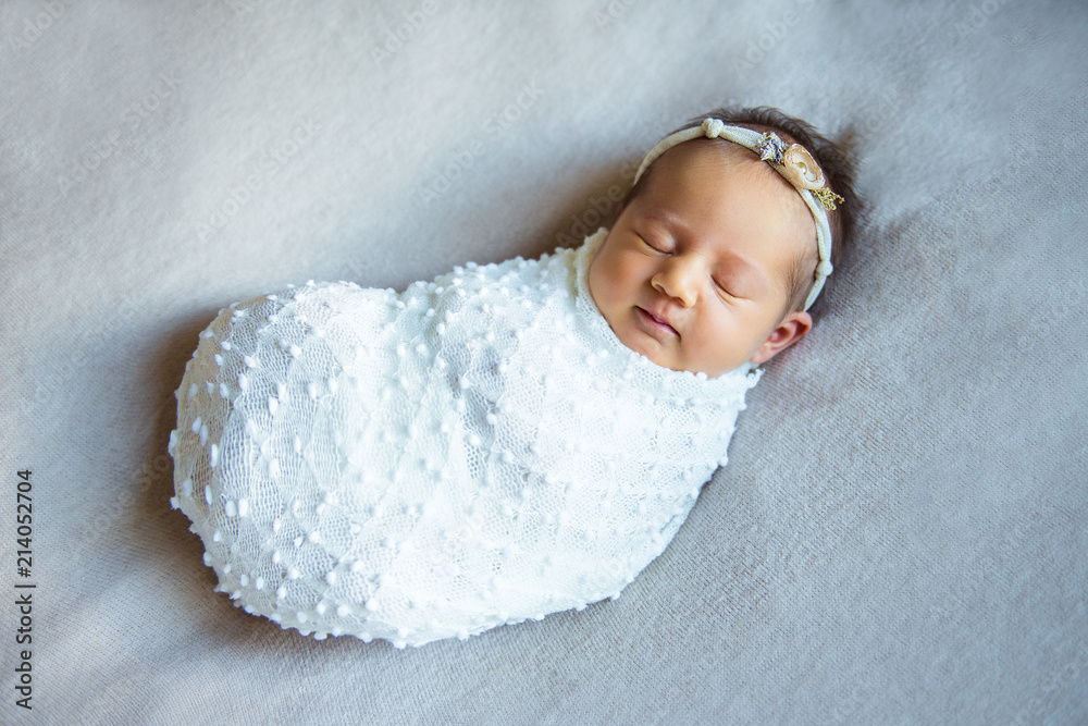 Newborn baby girl sleeping and yawning wrapped in a cocoon Stock Photo ...