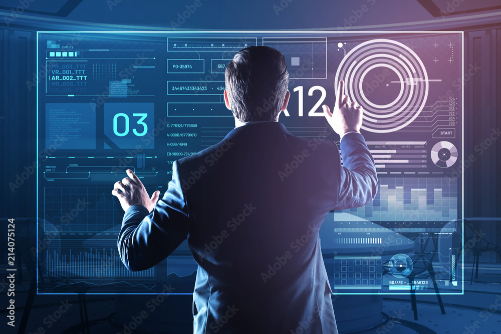 Working with transparent device. Calm attentive computer system analyst ...