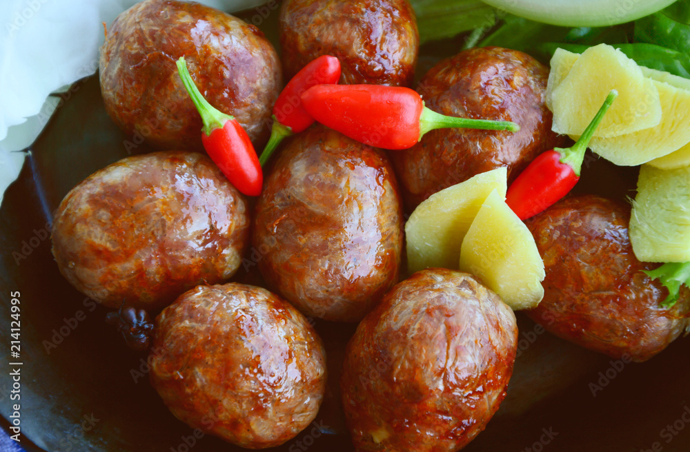 Easten thai sausage (Thai name is Sai Krok Isan) cooked and uncooked ...