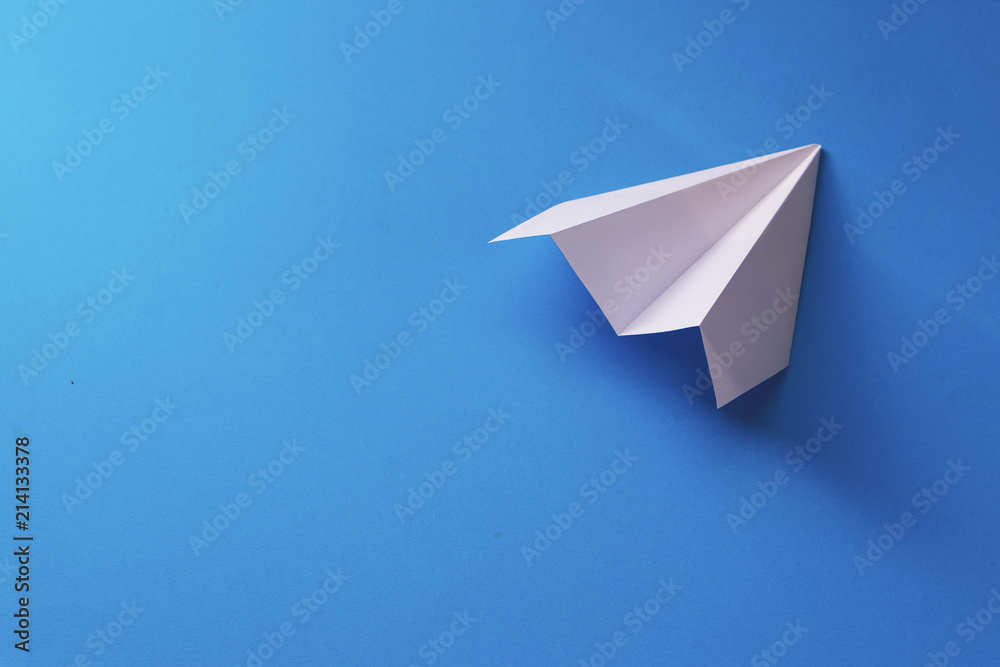 paper plane on blue background Stock Photo | Adobe Stock