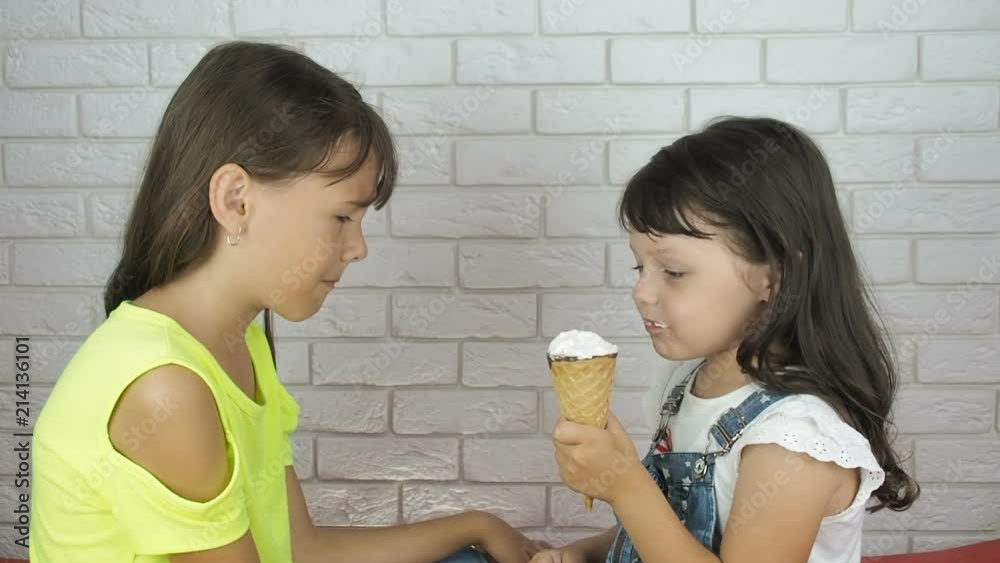 Greedy child. The child eats ice cream. The little girl does not give ...