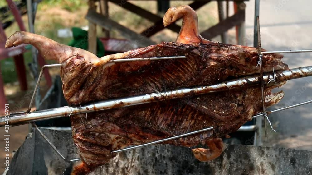 Traditional Thai style roasting piglet. Grilled pig at street food in ...