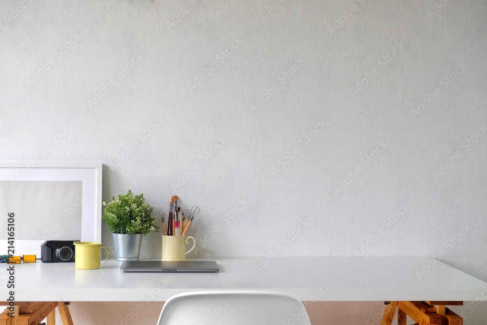 Stylish workspace with poster and gadget..Workplace desk and copy space ...