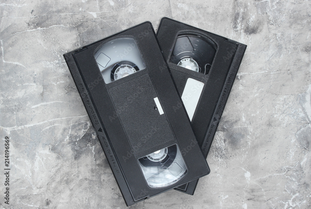 Retro vhs video cassettes from the 80s on a gray concrete background ...