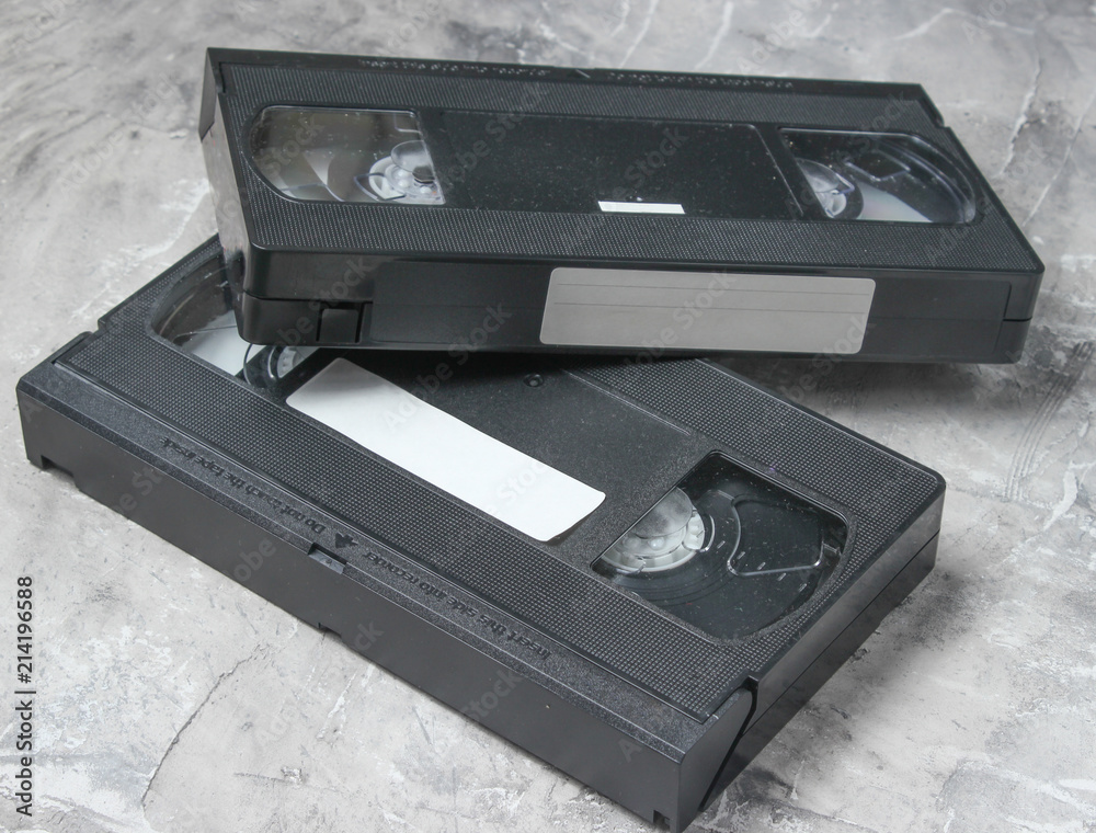 Retro vhs video cassettes from the 80s on a gray concrete background ...