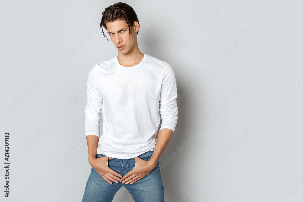 Strong face male model in casual style in white t sirt and jeans on ...