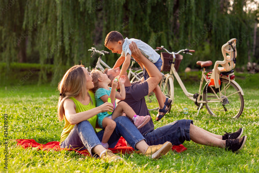 family, happiness, childhood and people concept - father raising his ...