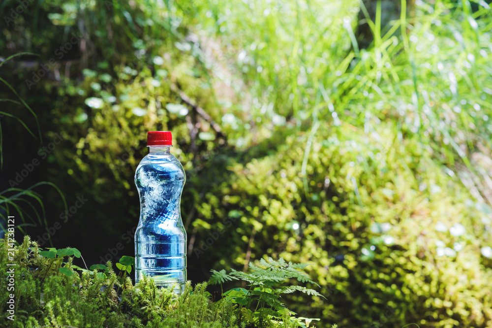 Transparent plastic A bottle of clean water with a red lid stands in ...