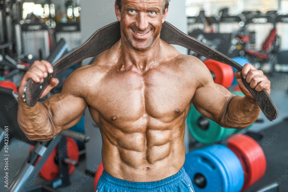 Brutal aged strong bodybuilder athletic men pumping up muscles with ...