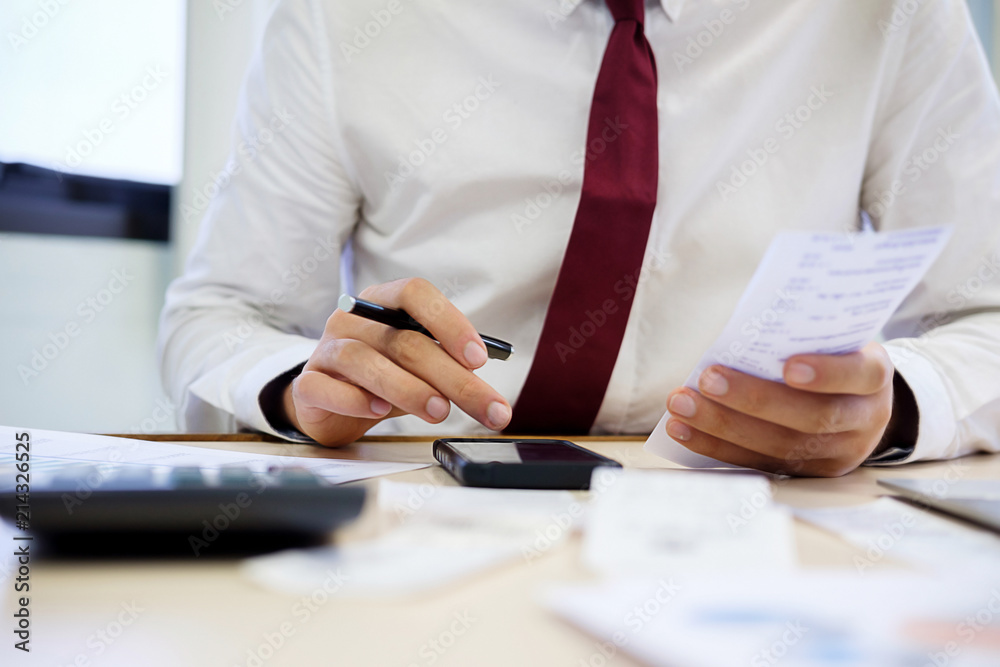 an with bills and calculator. Woman using calculator to calculate bills ...