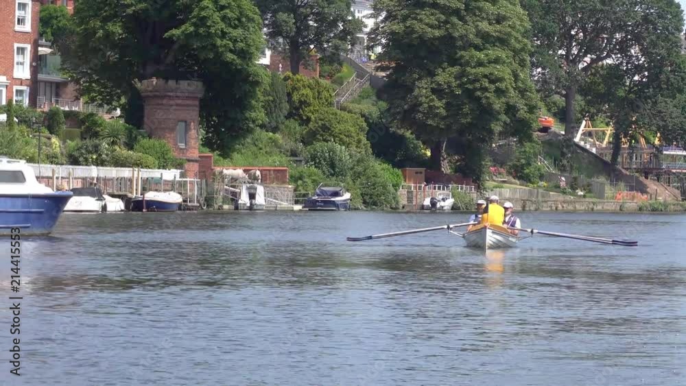 middle aged gentlemen enjoying a relaxing afternoon rowing a boat along ...