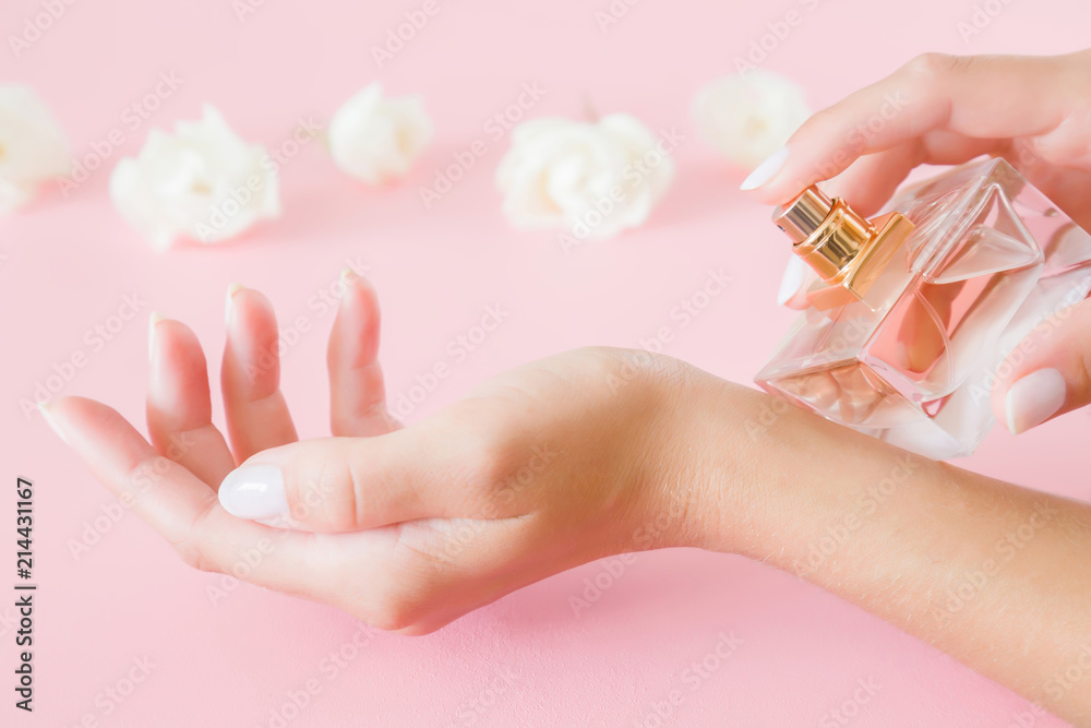 Young, perfect, groomed woman's hands holding a perfume bottle. Care ...