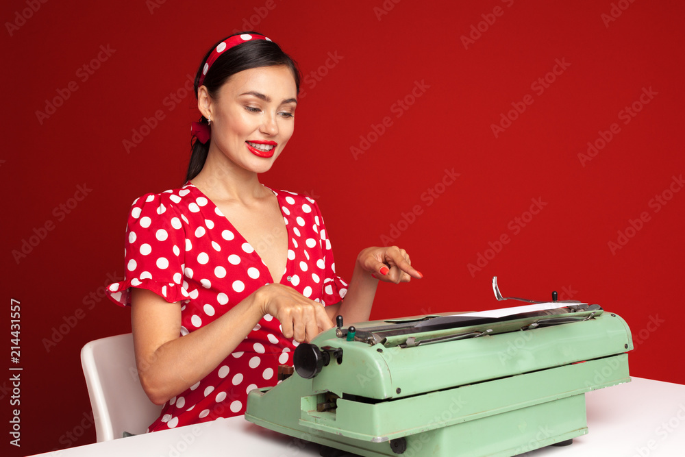 pin up girl typing on a typewriter Stock Photo | Adobe Stock