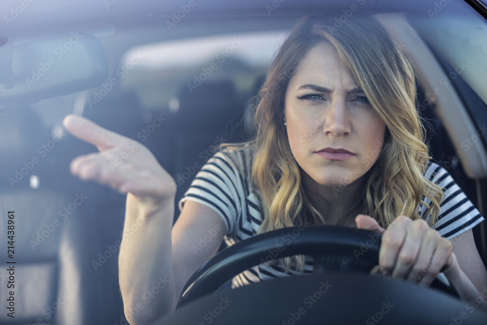 Angry woman driving a car. Stock Photo | Adobe Stock