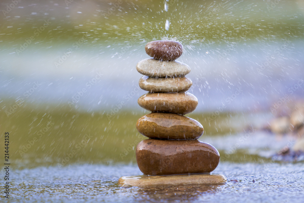 Close-up abstract image of water pouring down on rough natural brown ...