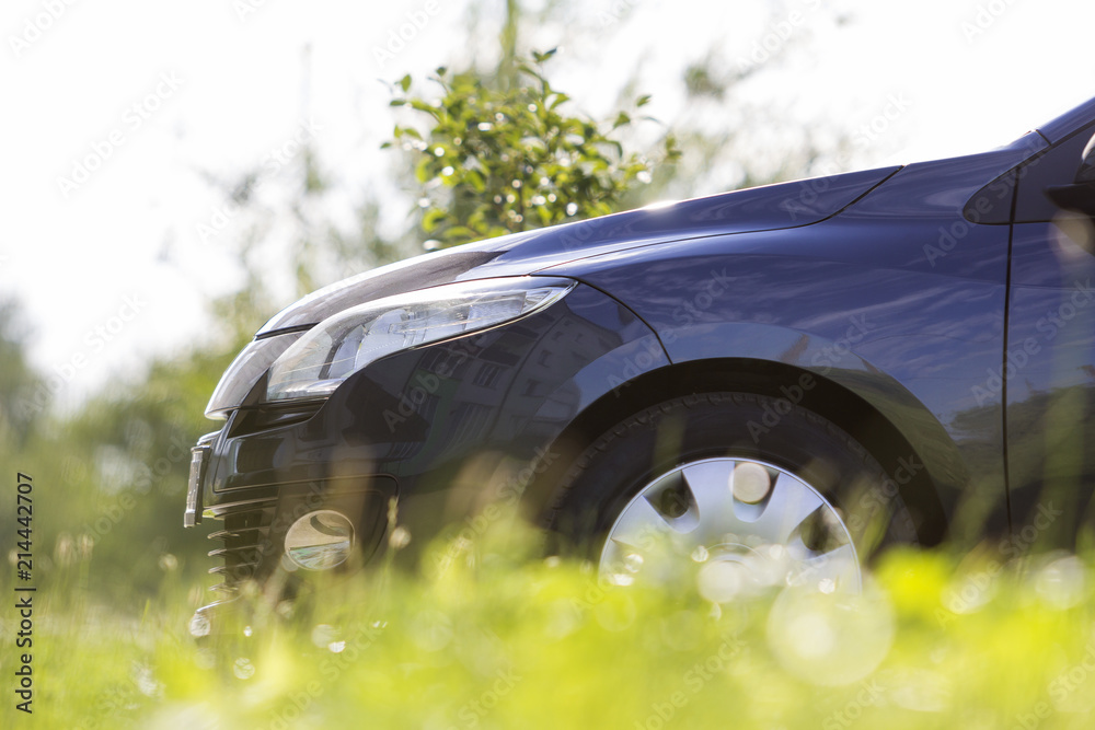 Close-up detail front of modern new shiny empty black car parked ...