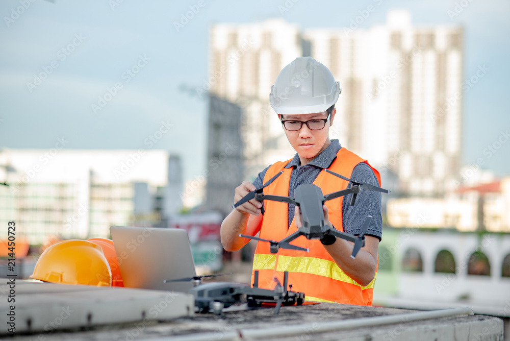Young Asian engineer man working with drone laptop and smartphone at ...