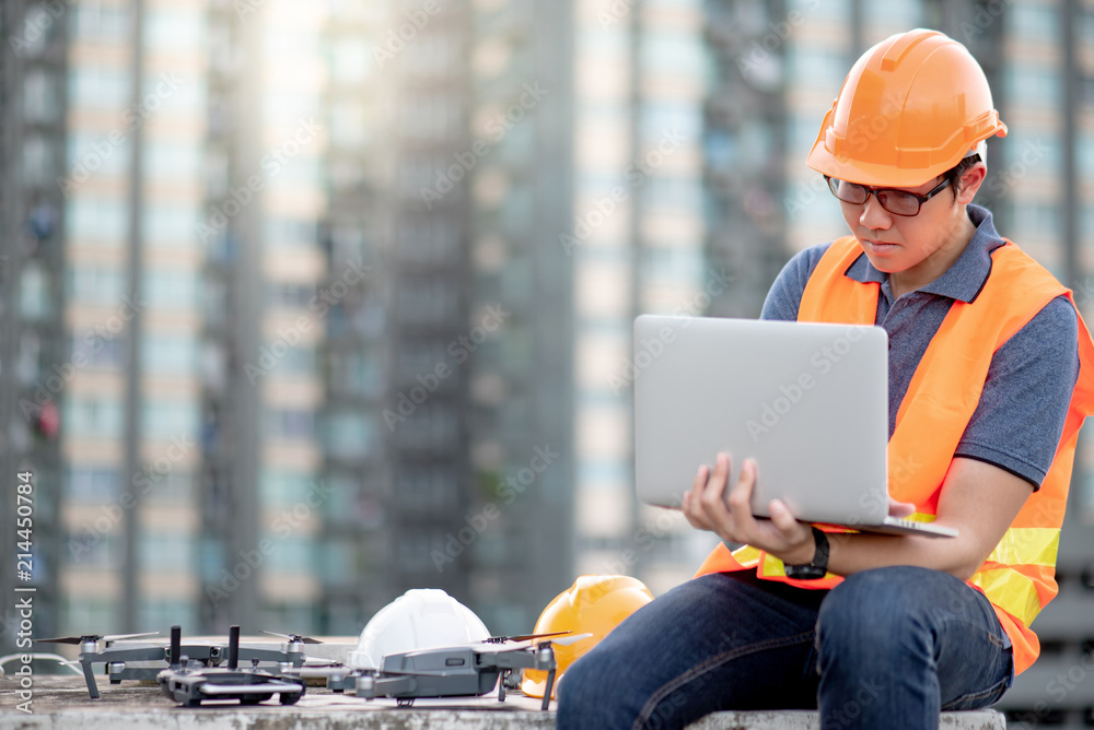 Young Asian man working with drone laptop and smartphone at ...