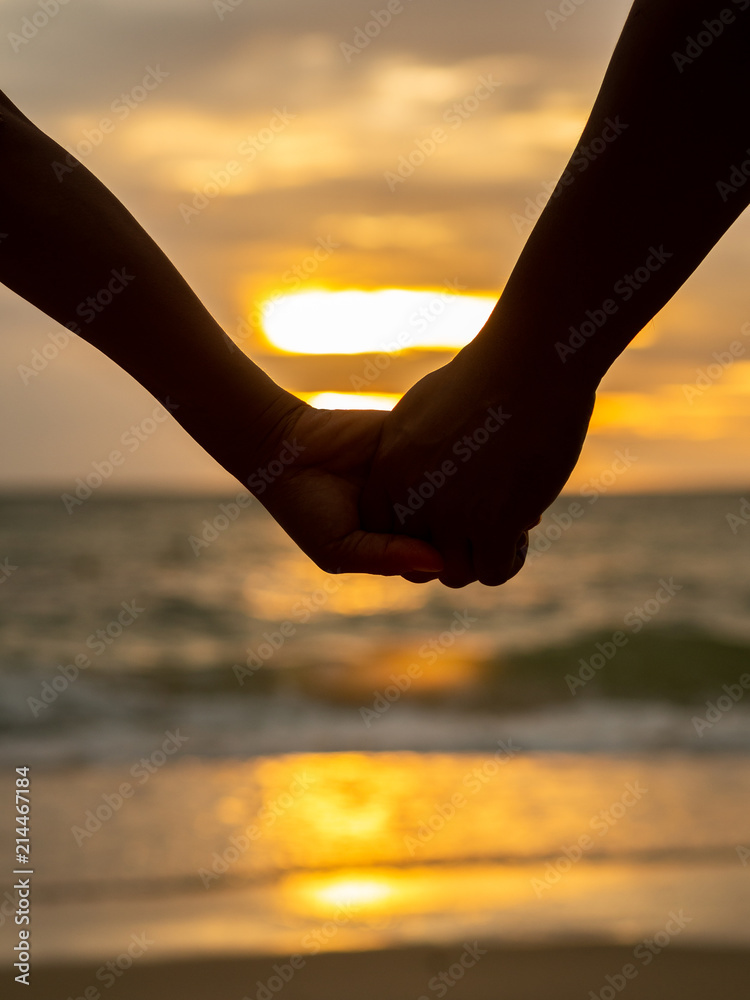 Couples In The Sunset Holding Hands