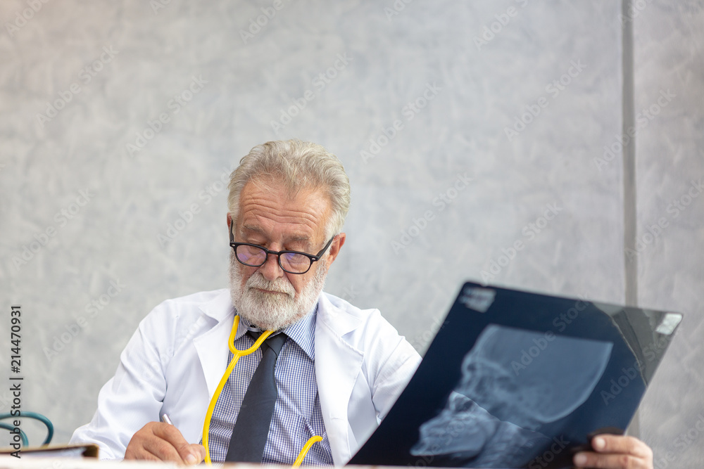 Senior medical doctor or chief doctor or Surgeon are checking skull of ...