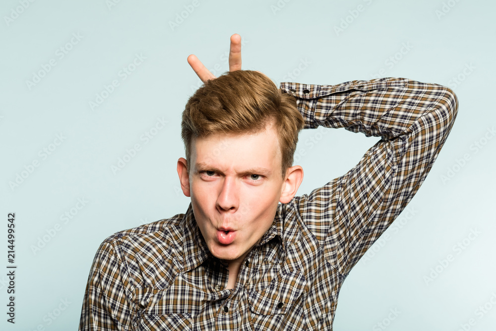 funny joyous happy frolic playful man fooling around giving bunny ears ...