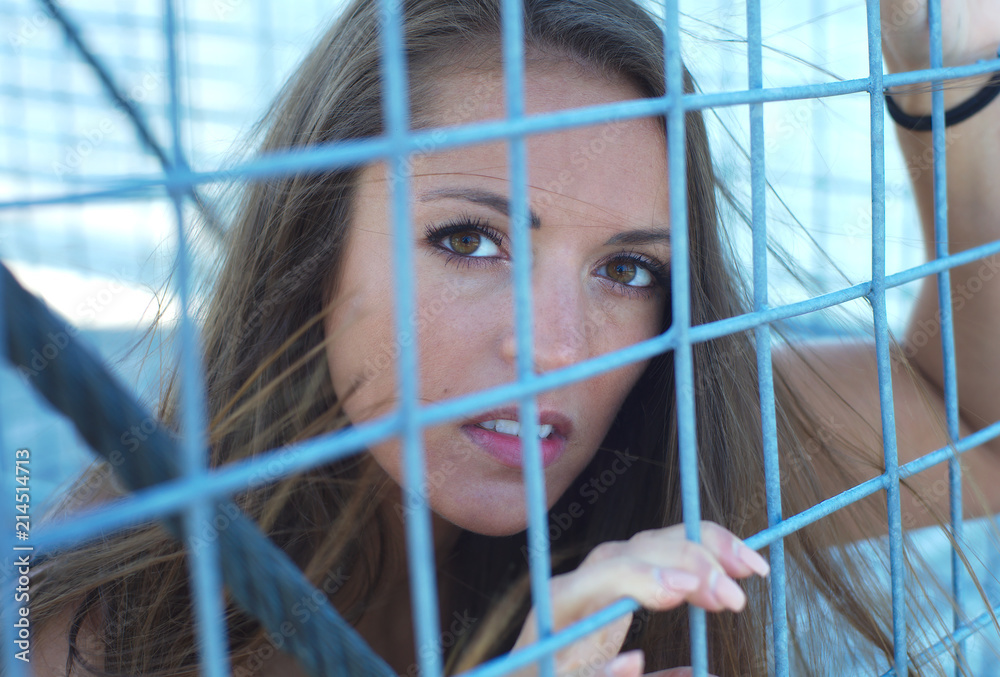 women rights restriction girl in prison metal grid fence Stock Photo ...