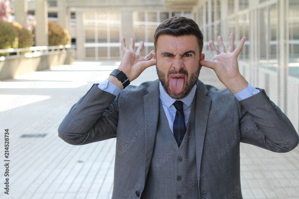 Childish businessman doing an obscene gesture Stock Photo | Adobe Stock