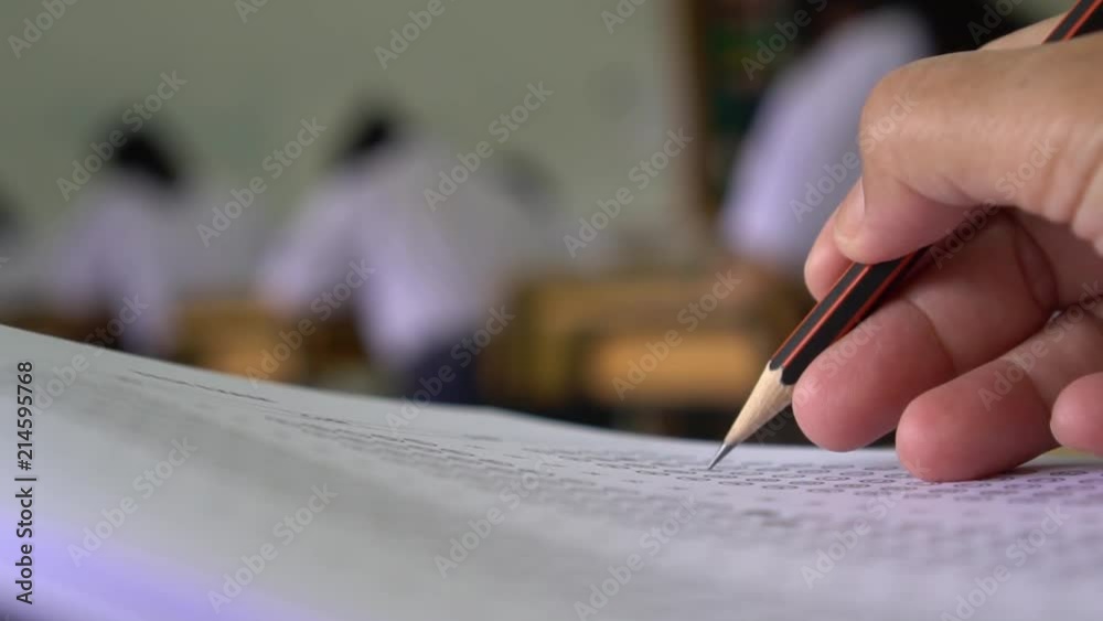 Hands with pencil over application form, Students taking exams, writing ...