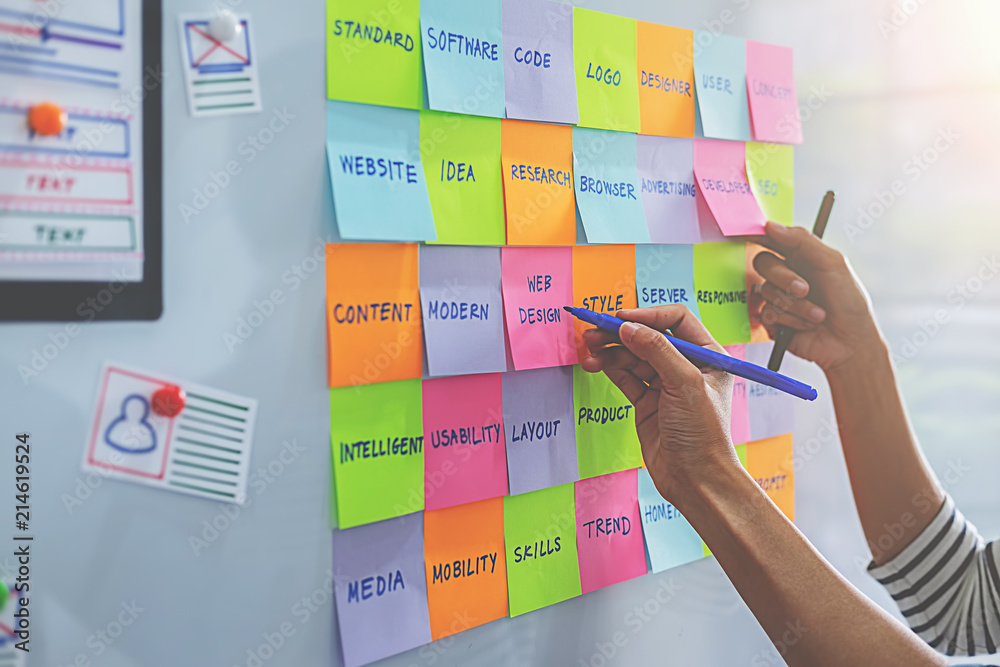 Web designer brainstorming for a strategy plan. Colorful sticky notes ...