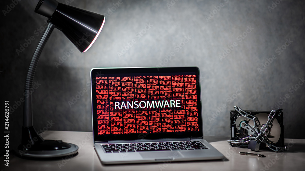 Laptop computer screen with ransomware attacking alert in red digital ...