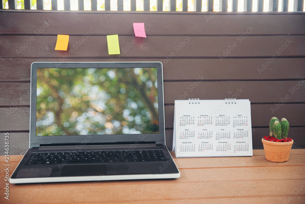 Desktop Calendar page,cactus and laptop place on wood office desk ...