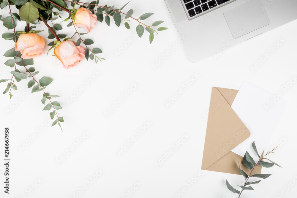 Styled feminine desk workspace with pink roses, laptop computer, green ...
