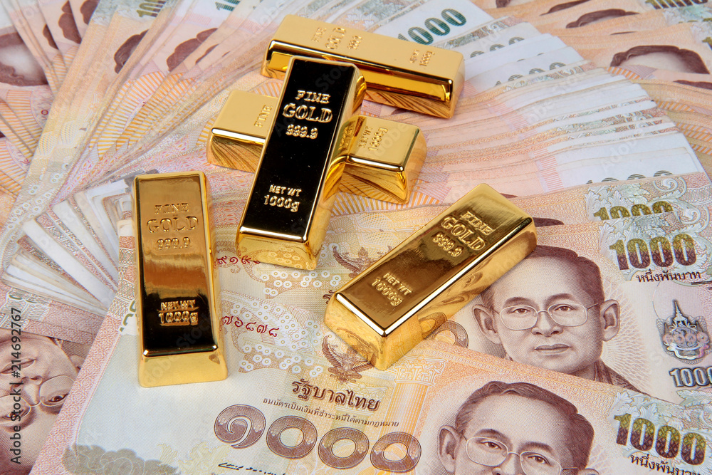 5 of 1 kg. Gold bar on 1000 Baht of Thailand banknotes nested a pile ...