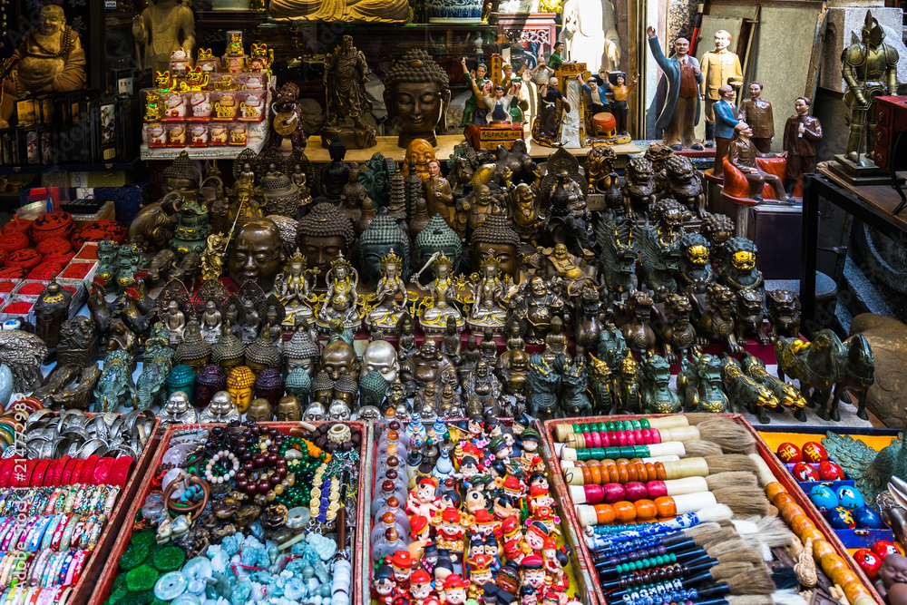 Selection of Chinese statues and souvenirs displayed in a gift shop at ...