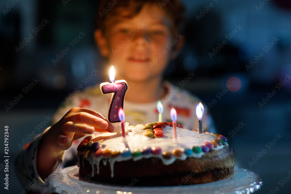 Adorable happy blond little kid boy celebrating his 7 birthday. Stock ...