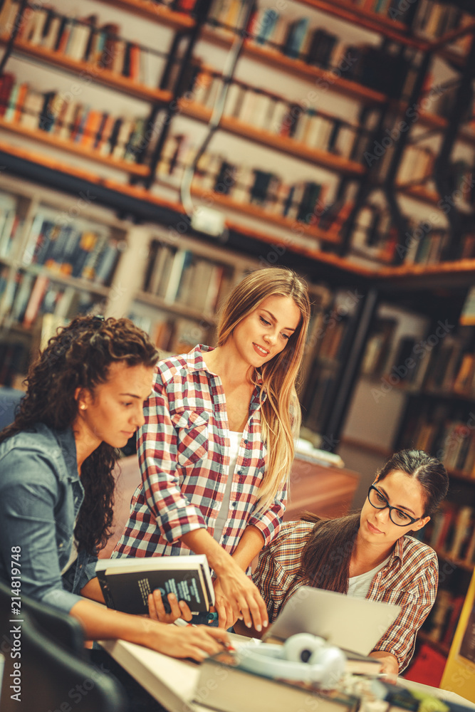 Cute female students study in the university campus library.Learning ...
