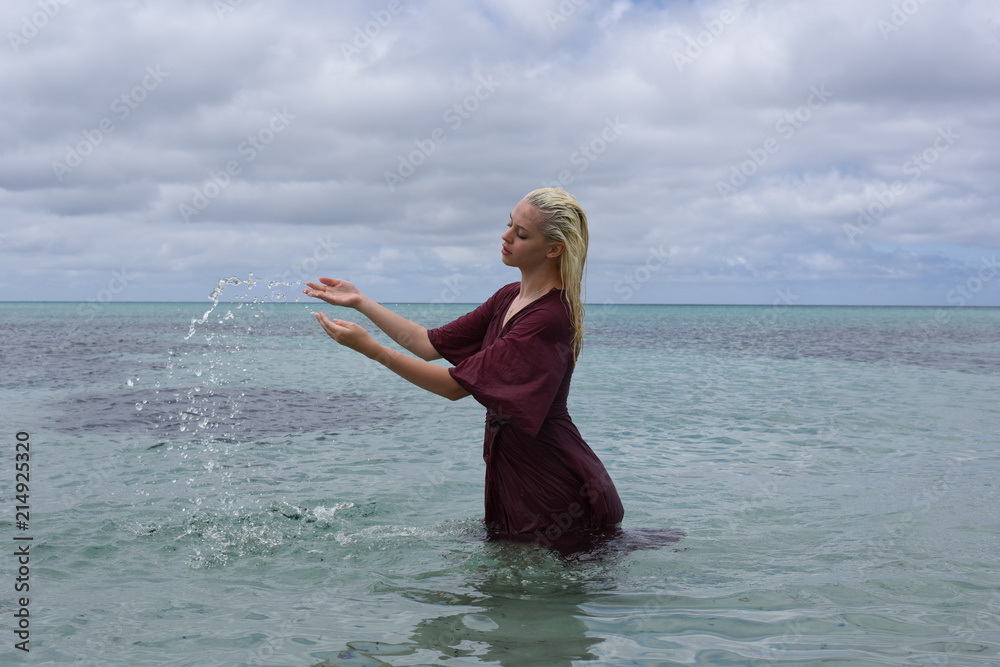 portrait of pretty blonde girl wearing purple dress, posing in a ...